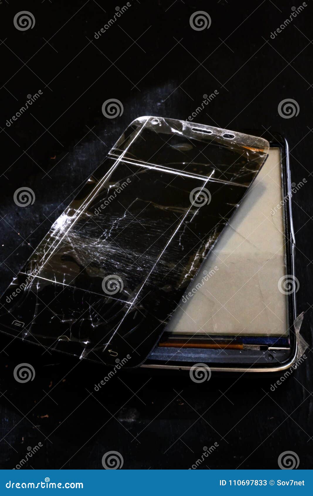 Broken Black Mobile Smartphone with a Cracked Display on a Black Table ...