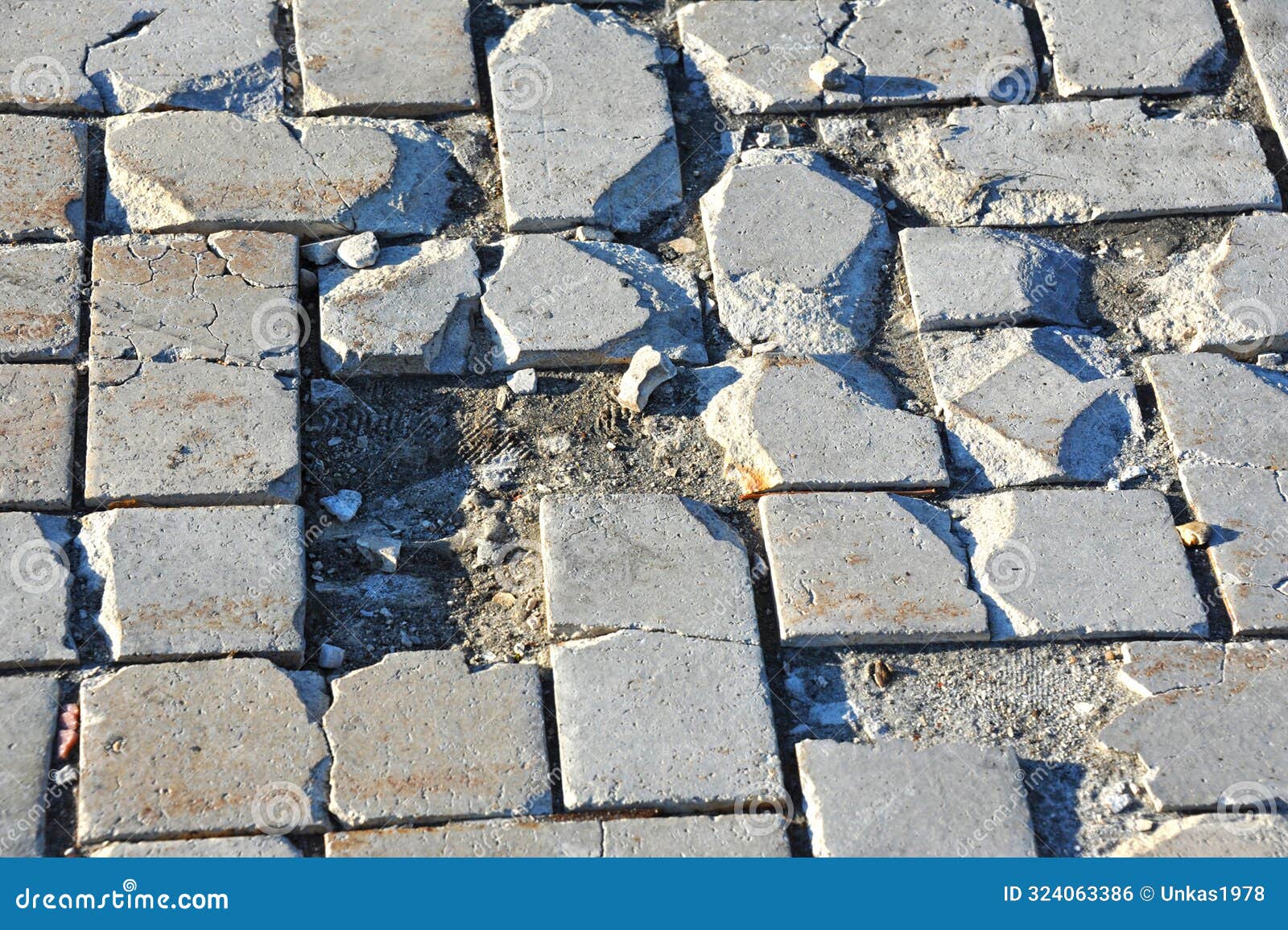 Broken pavement tile stock photo. Image of masonry, stone - 324063386