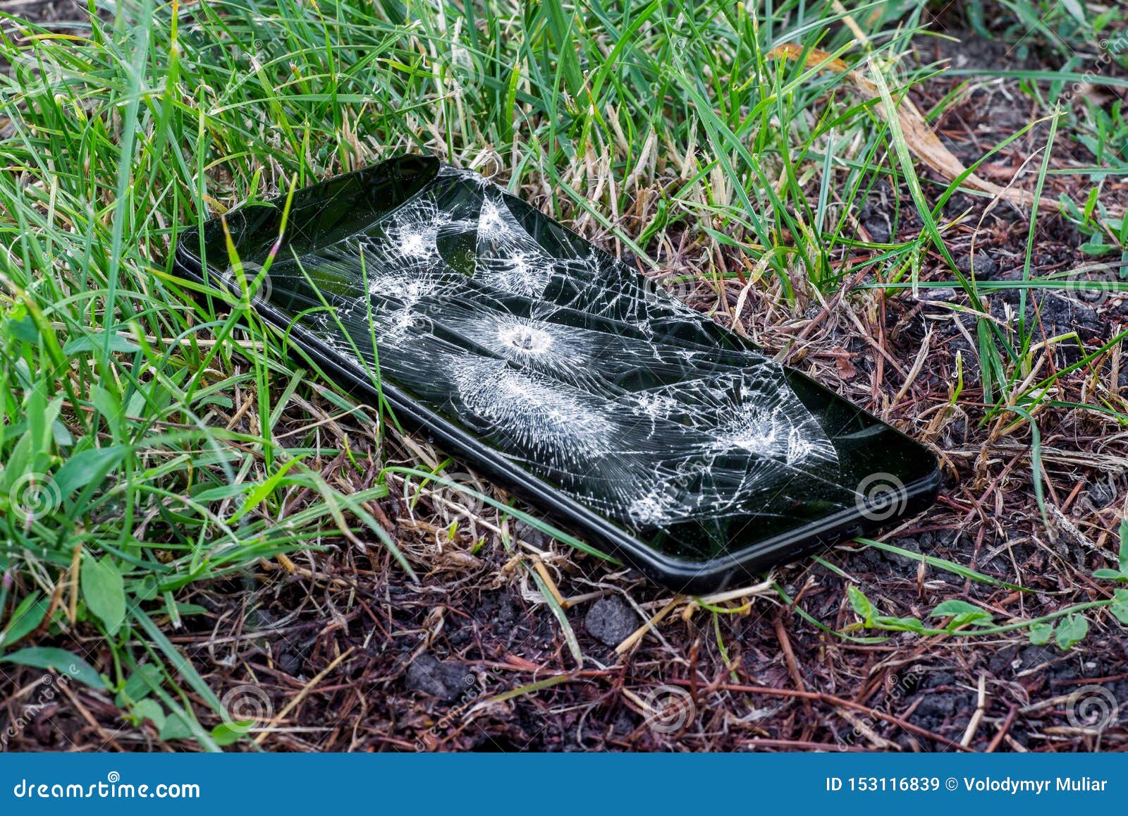Broken Phone with Hole from Bullet in Grass_ Stock Image - Image of ...