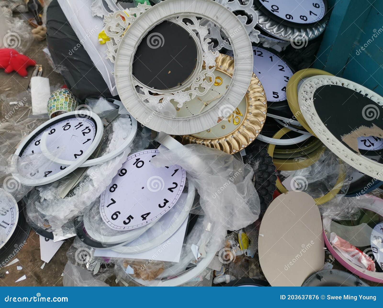 Broken Pieces of Wall Ceiling Clock at the Dumpster. Stock Photo ...