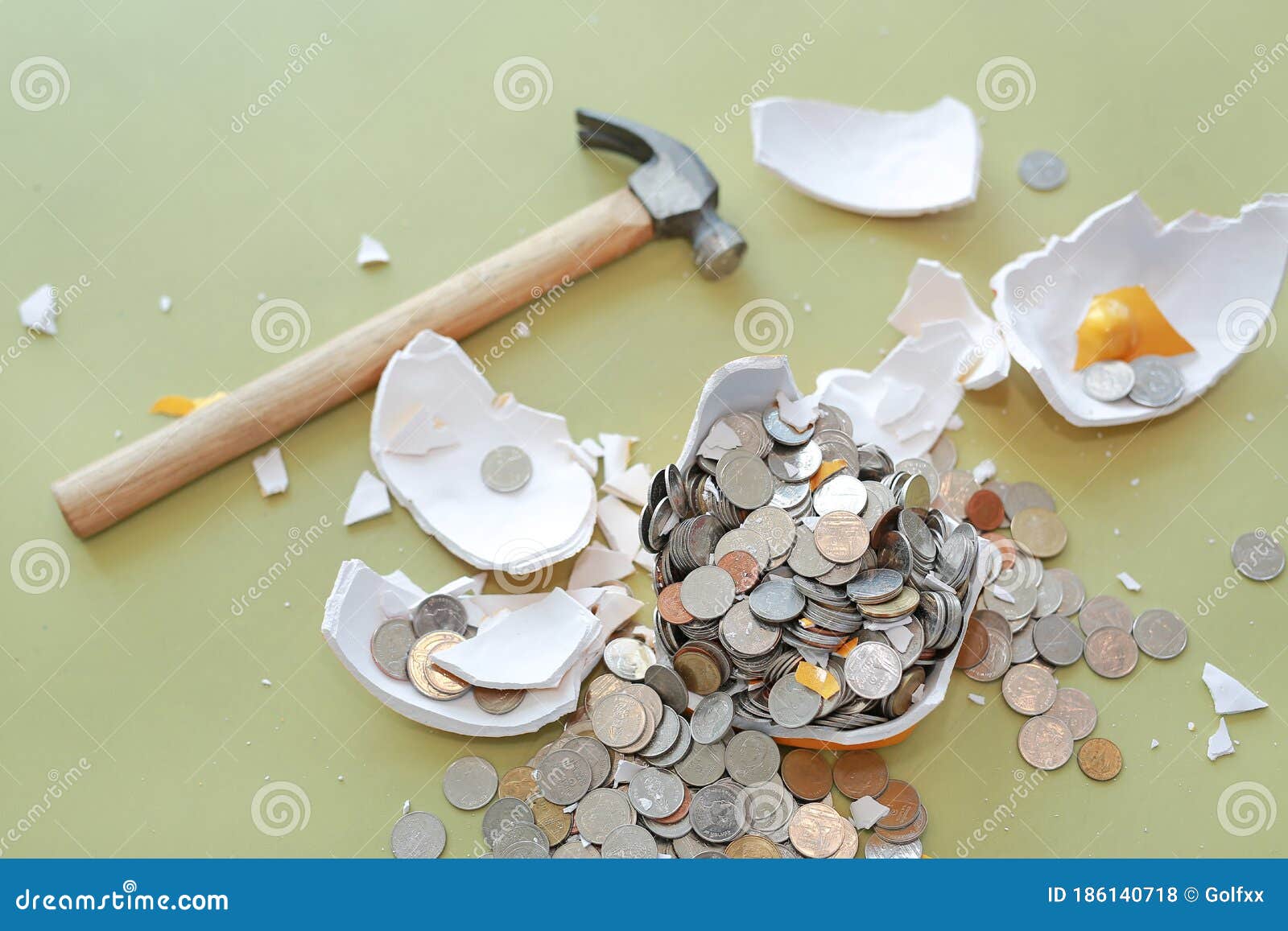 Broken Piggy Bank with Hammer and Coins on Table Stock Photo - Image of ...