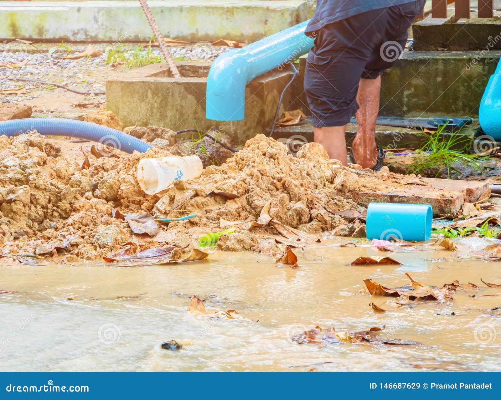 Broken Pipe in Hole with Water Motion at Roadside and Plumber Working ...