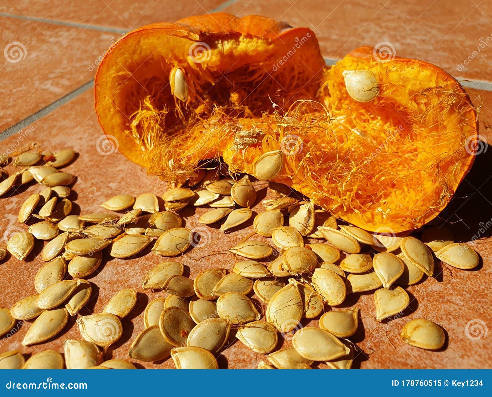 Broken Pumpkin in Half with Scattered Seeds on the Stone Surface Stock ...
