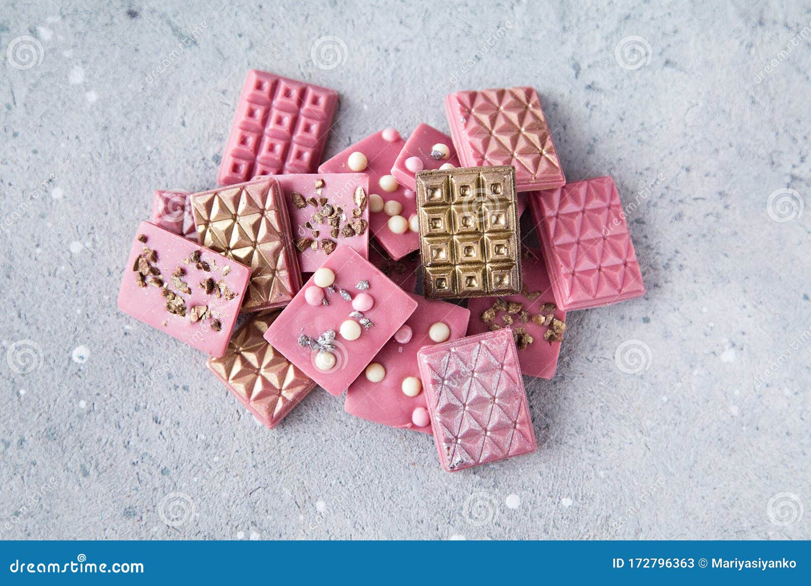 Broken and Shattered Pieces of Ruby Pink Chocolate on Ligth Grey ...
