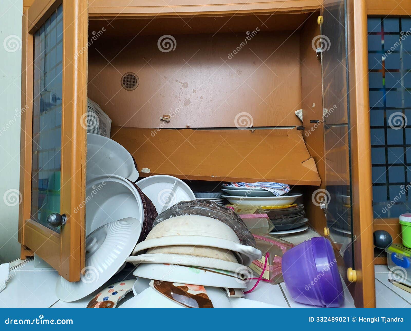 The Broken Shelf in the Cabinet Caused the Plates and Bowls To Fall and ...