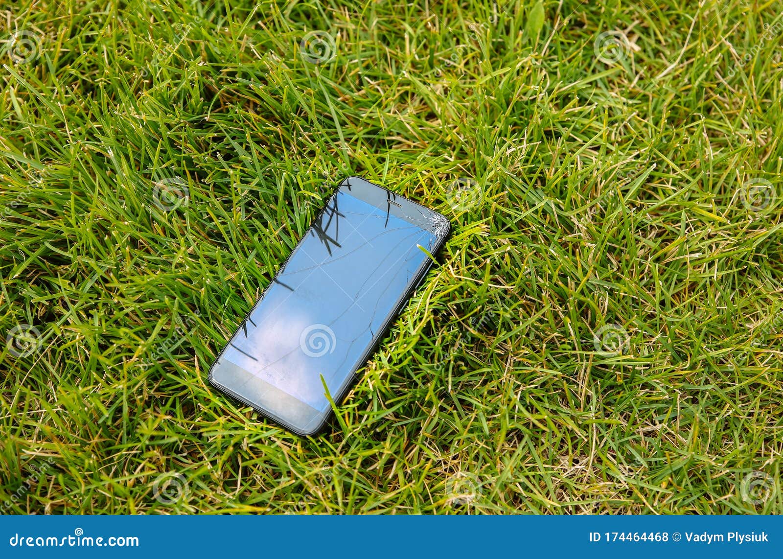 Broken Smartphone Lying in the Green Grass Lawn Outdoors. Damaged ...