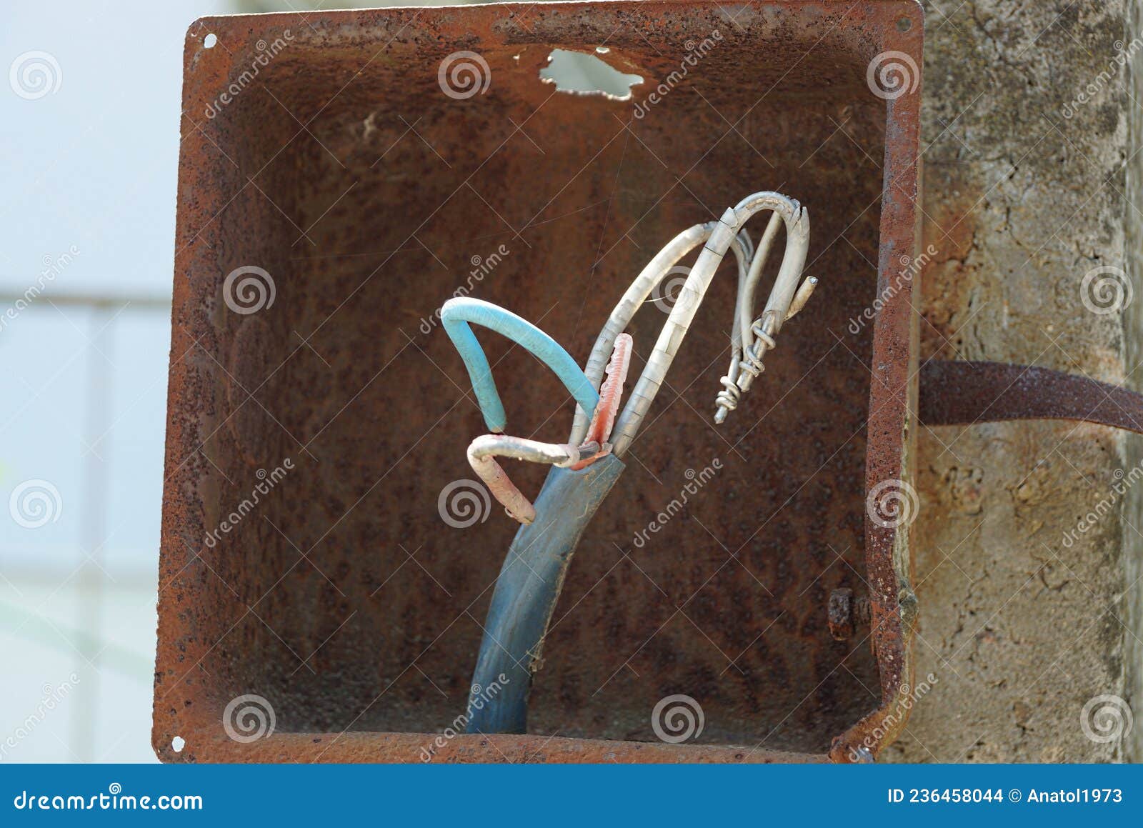 A Broken Square Metal Box Covered in Brown Rust with Pieces of Dangling ...