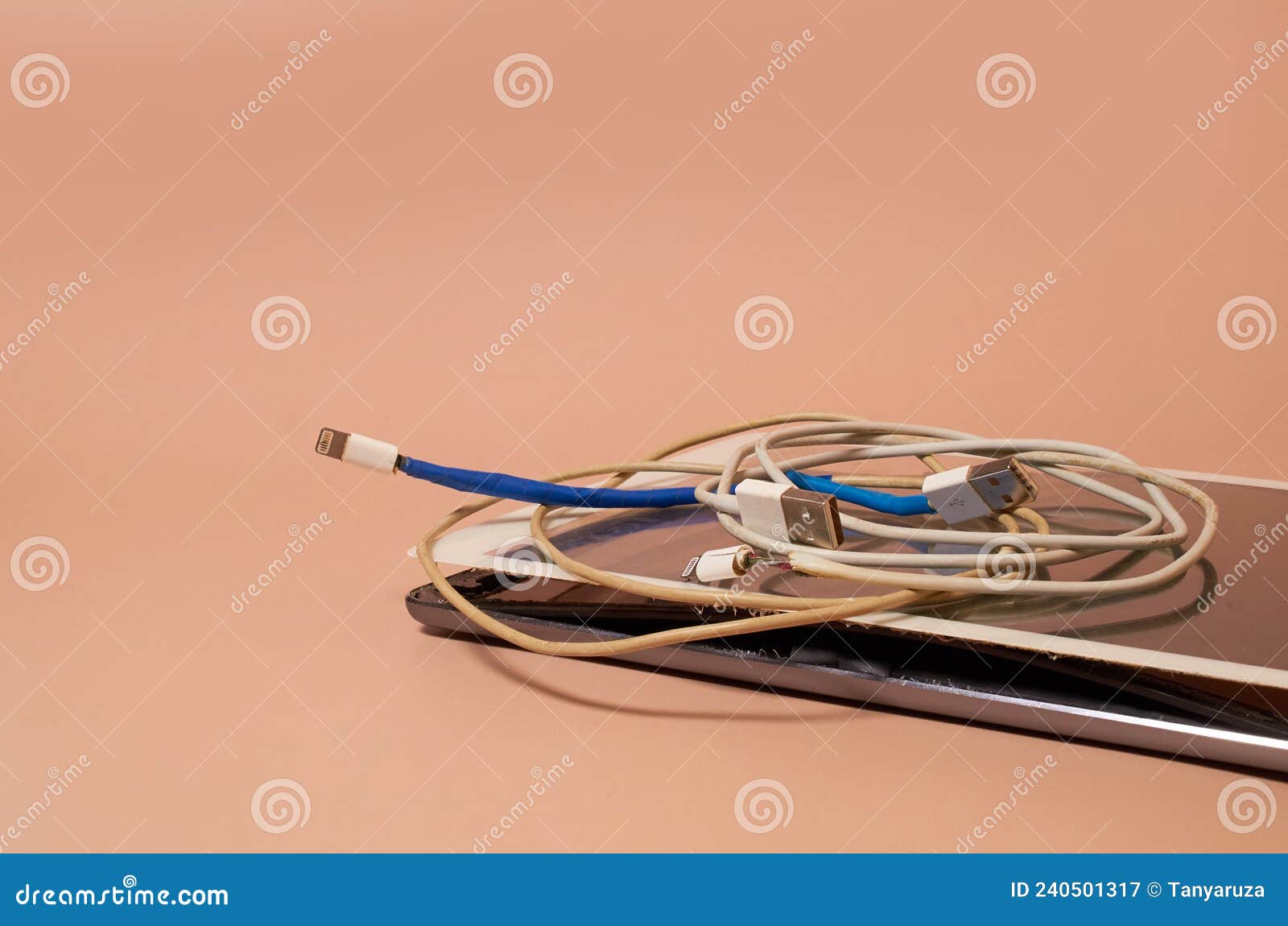 A Broken Tablet with a Swollen Battery and Two Bare USB Wires Stock ...