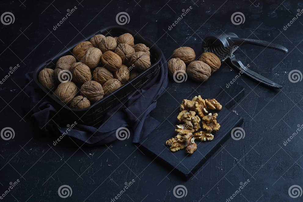 Broken Walnuts and Nutcracker on Black Background Stock Photo - Image ...