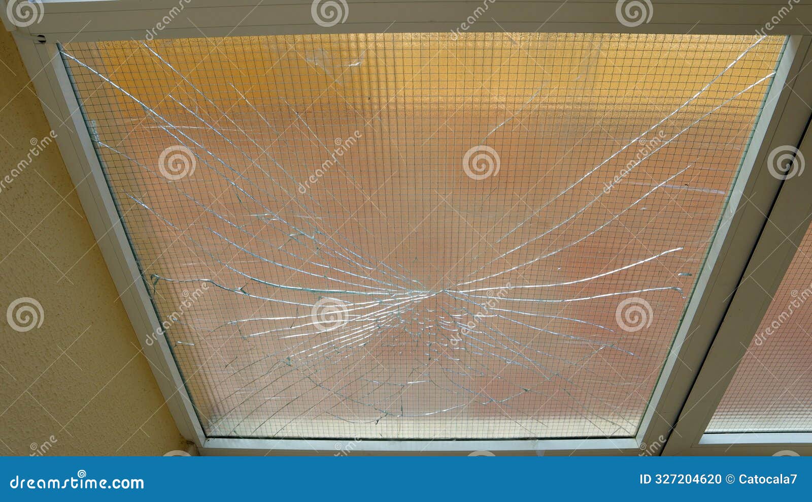 Broken Windowpane with Wire Mesh Behind it. Glass is Shattered with ...