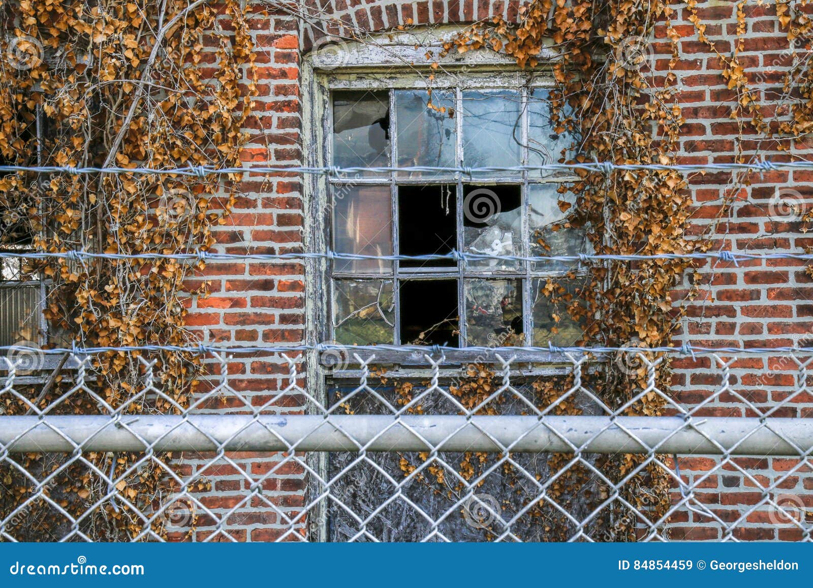 Broken Windows Behind Barb Wire and Fence Stock Image - Image of ...