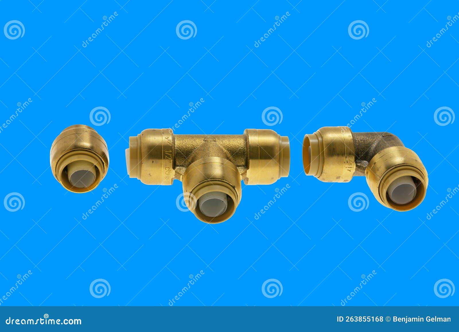 Bronze Angle Fittings for Water on a Blue Background Stock Photo ...