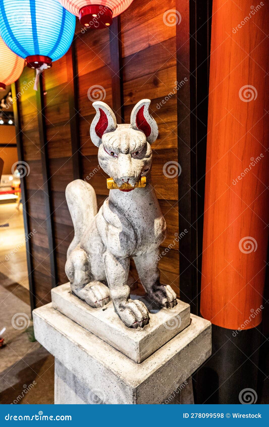 Bronze-colored Statue of a Japanese Kitsune Fox with Red Ears Stock ...