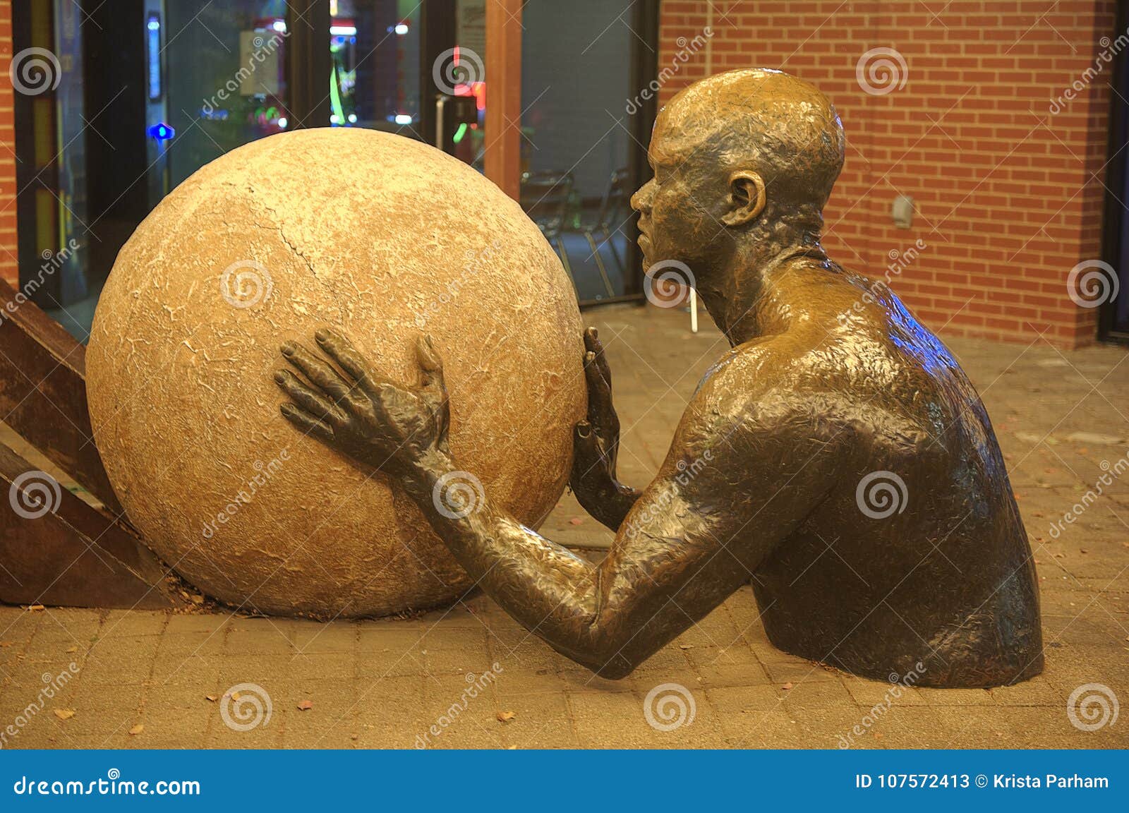 Bronze man with a ball editorial stock photo. Image of structures ...