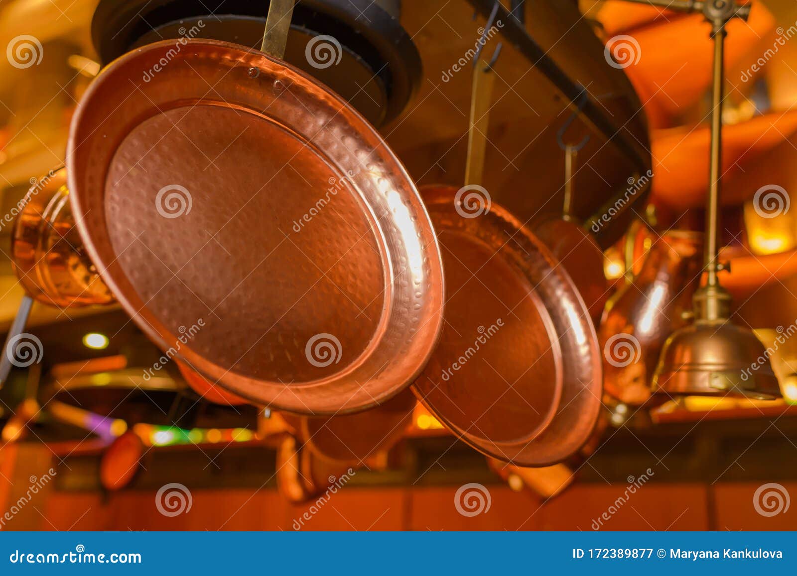 Bronze Pans Hang in the Kitchen. Frying Pan Close-up Stock Image ...
