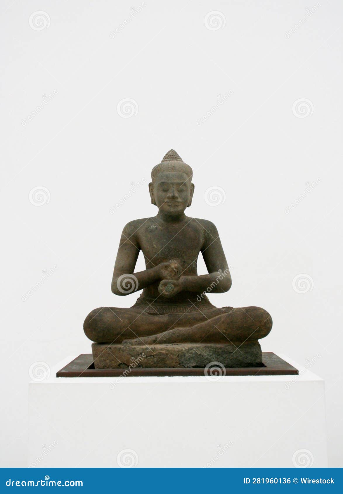 Bronze Statue of a Buddha Kneeling in a Meditative Pose Against a White ...