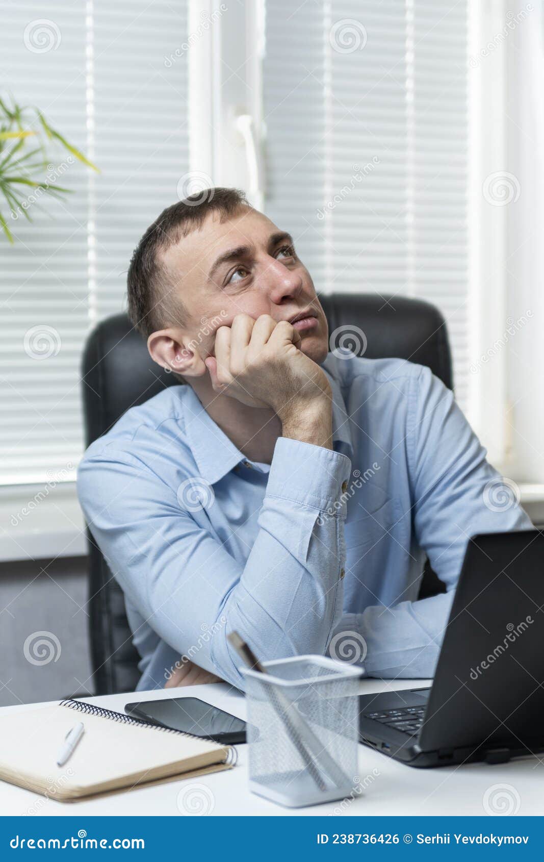 Brooding Young Man in the Office Behind the Workplace. Portrait of an ...