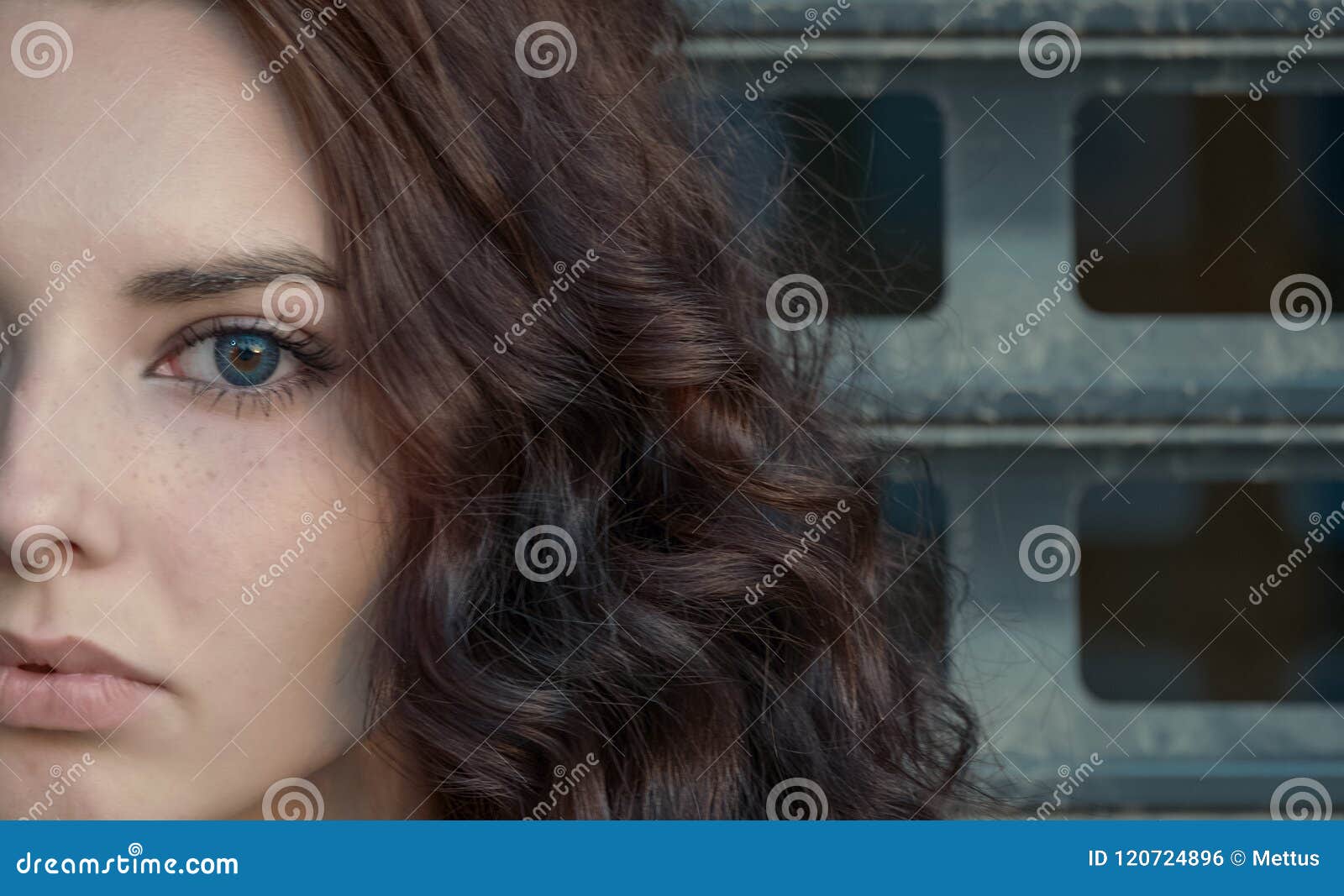 Broody Girl Half Face in Front of Metal Grid Looking at Camera Stock ...