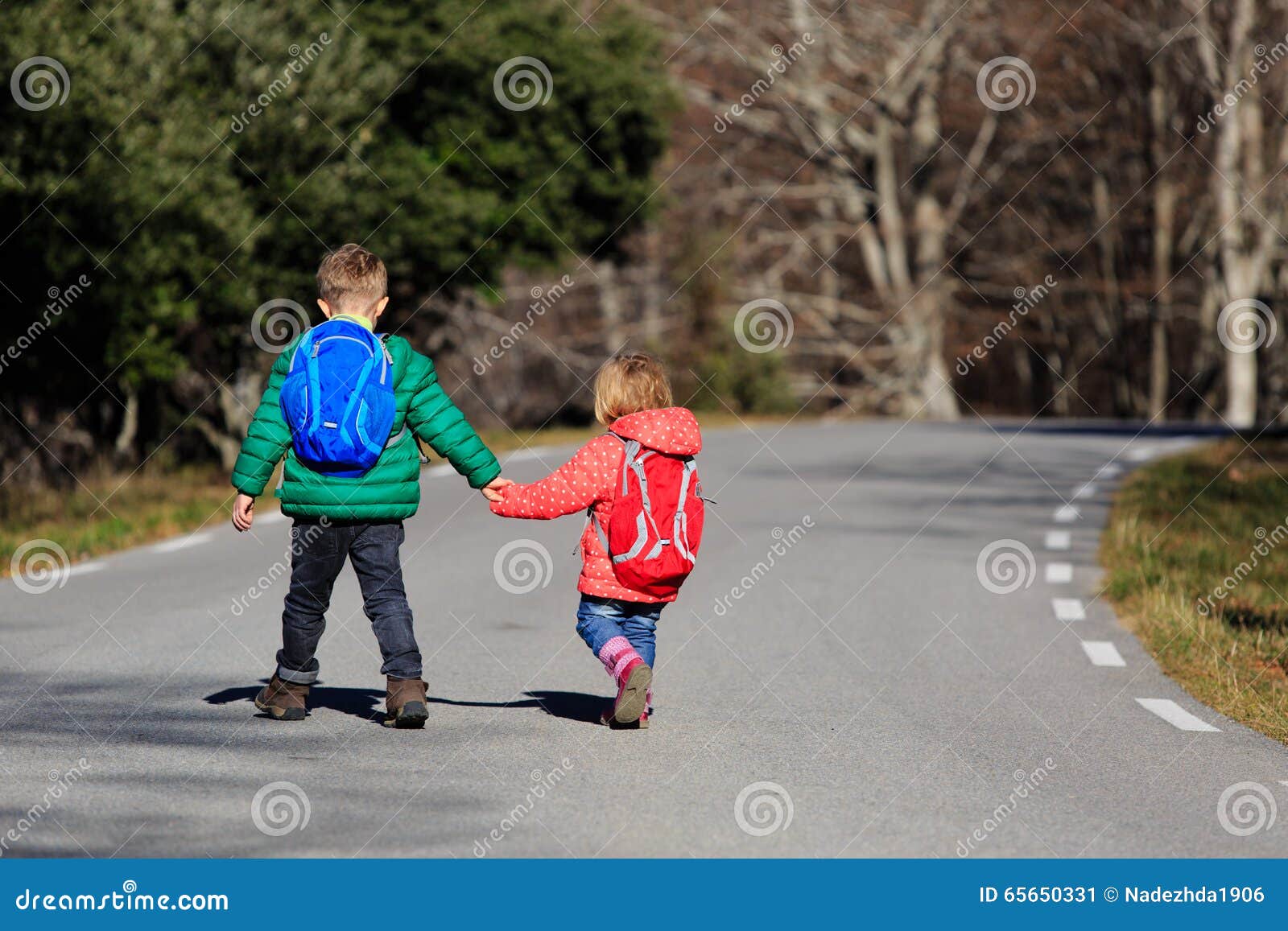 Brother and Sister with Backpacks Walking on the Road Stock Image ...