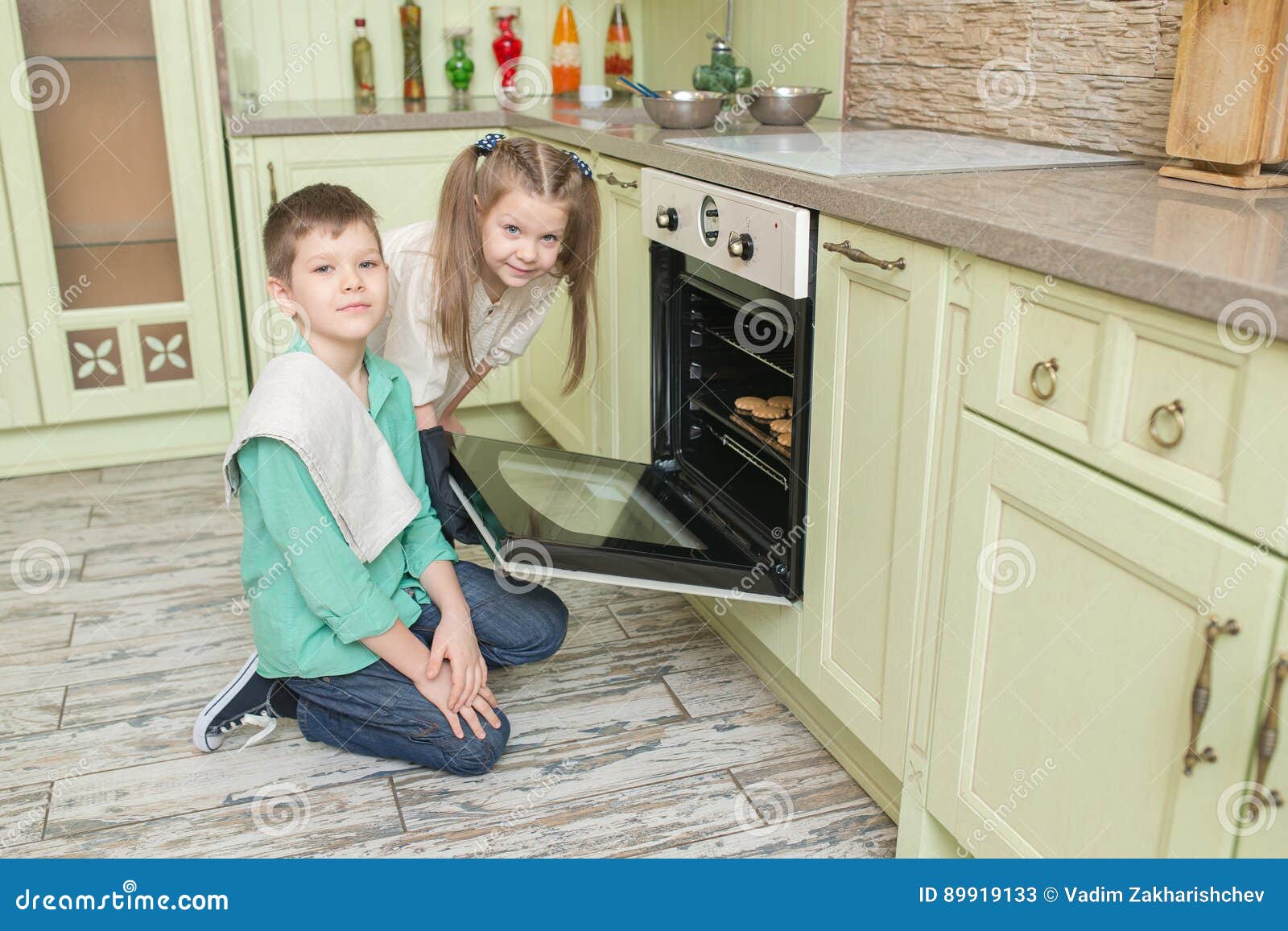 Brother and Sister Baking Cookies in the Oven in the Kitchen Stock ...