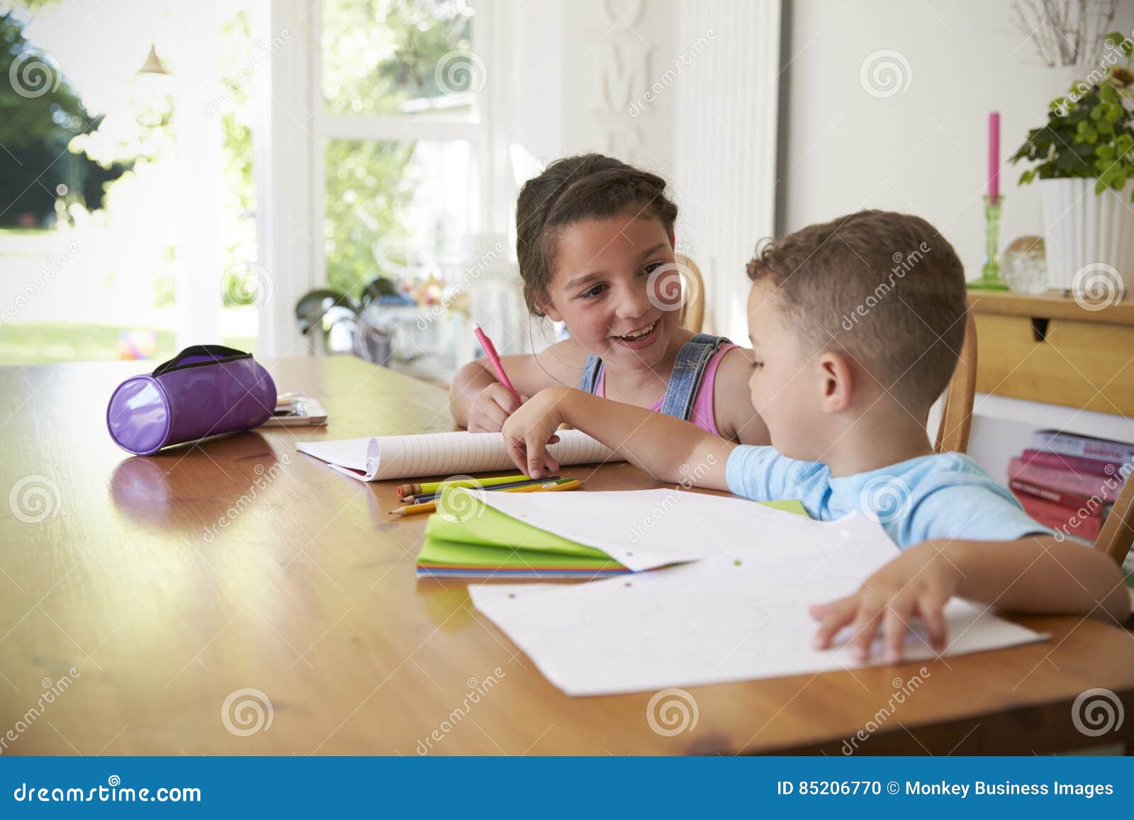 Brother and Sister Doing Homework at Table Stock Photo - Image of ...