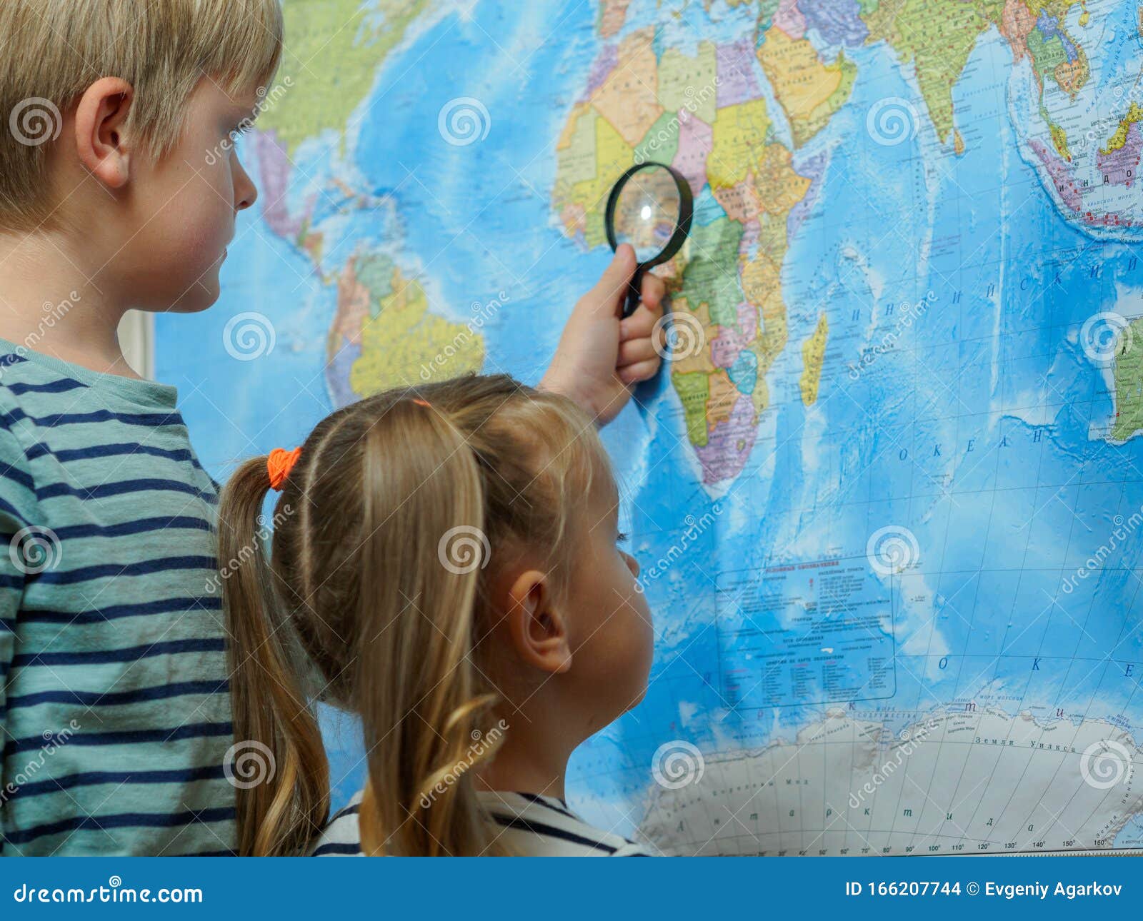 Brother and Sister Learning a Map through a Magnifying Glass, Slow ...