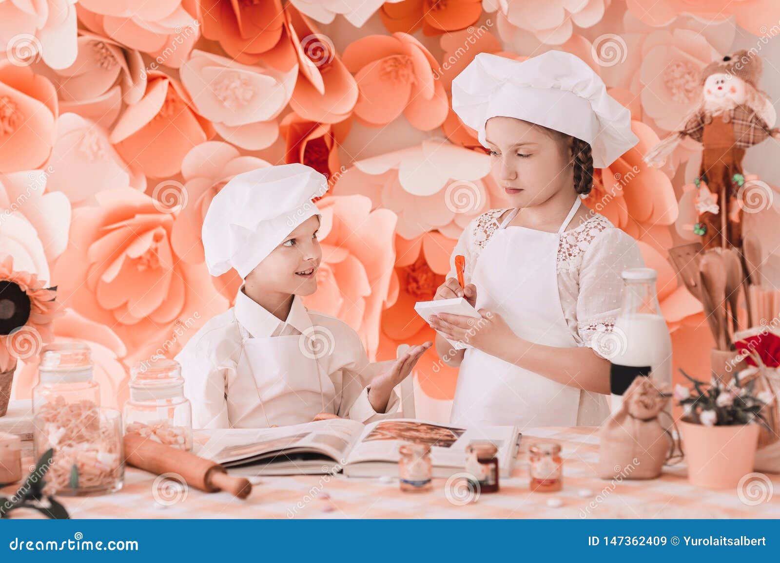 Brother and Sister in Uniform Chefs Record Menu Standing at the Kitchen ...