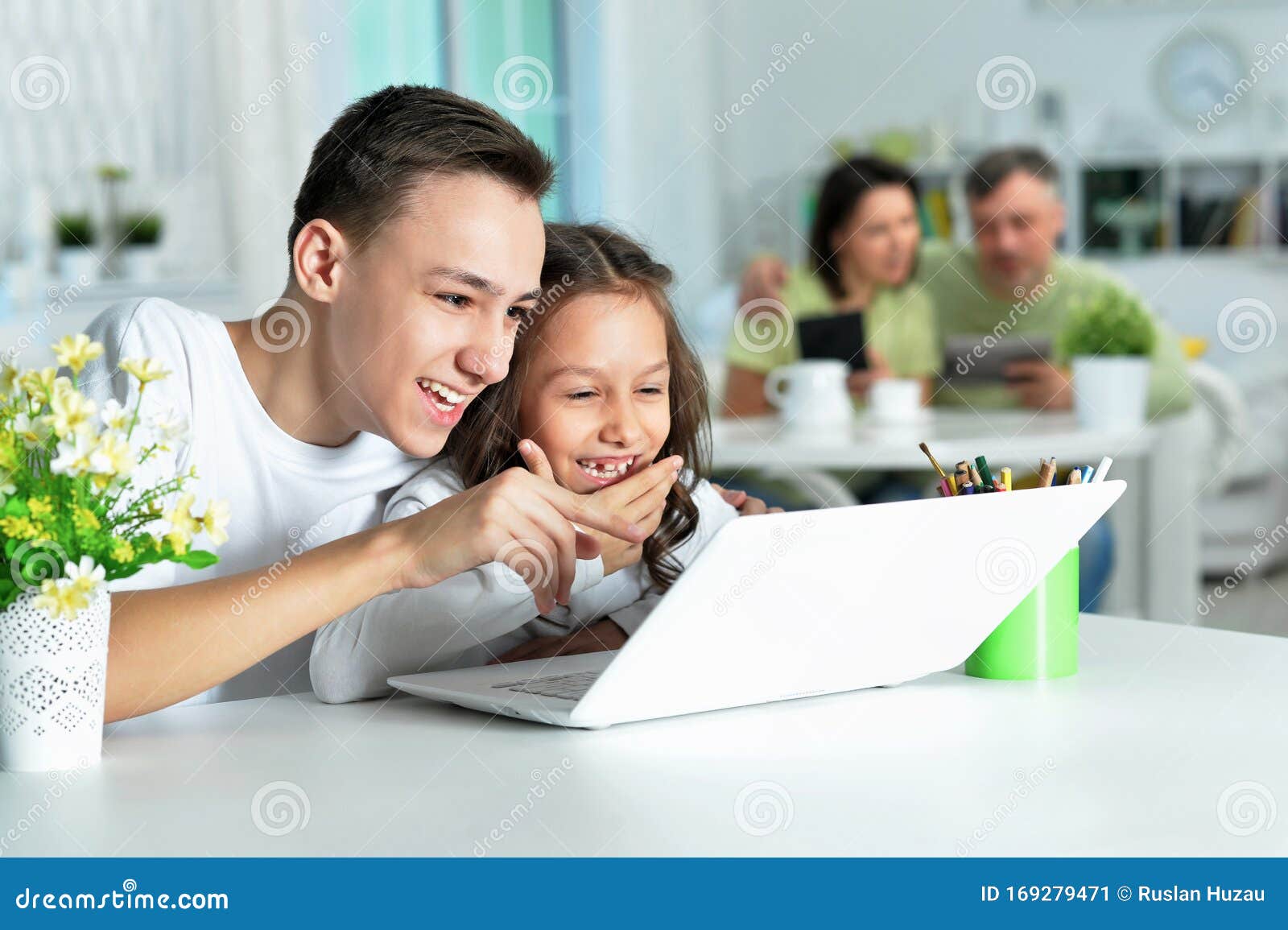 Brother and Sister Using Laptop while Sitting at Table Stock Image ...