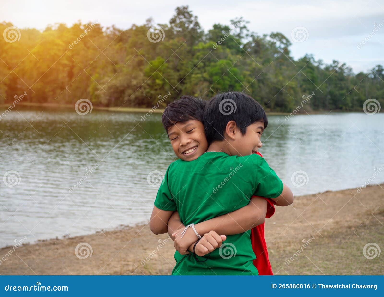 Brothers Hug Each Other by the Reservoir in the Evening Stock Photo ...