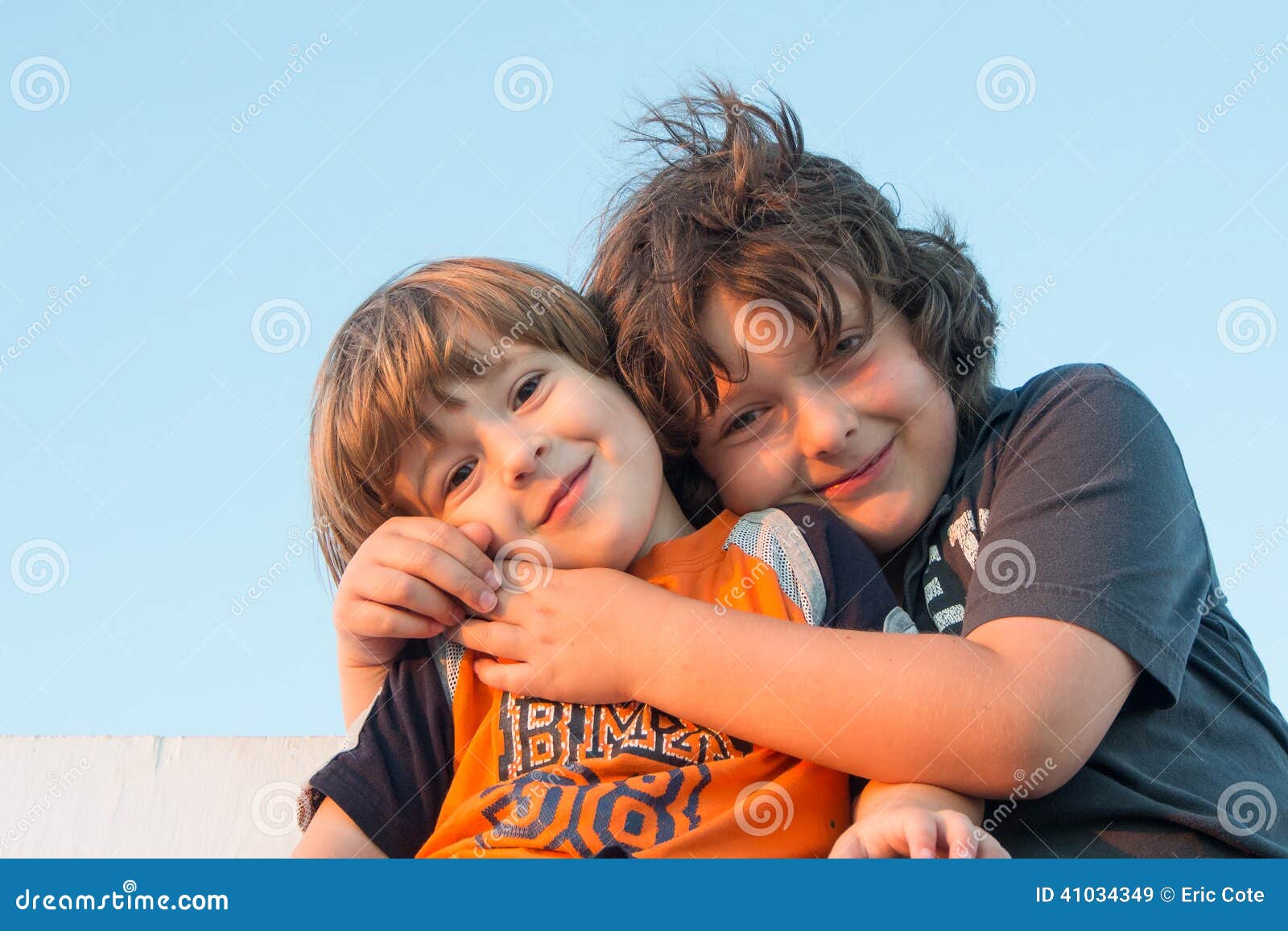 Brothers hugging at sunset stock image. Image of caucasian - 41034349