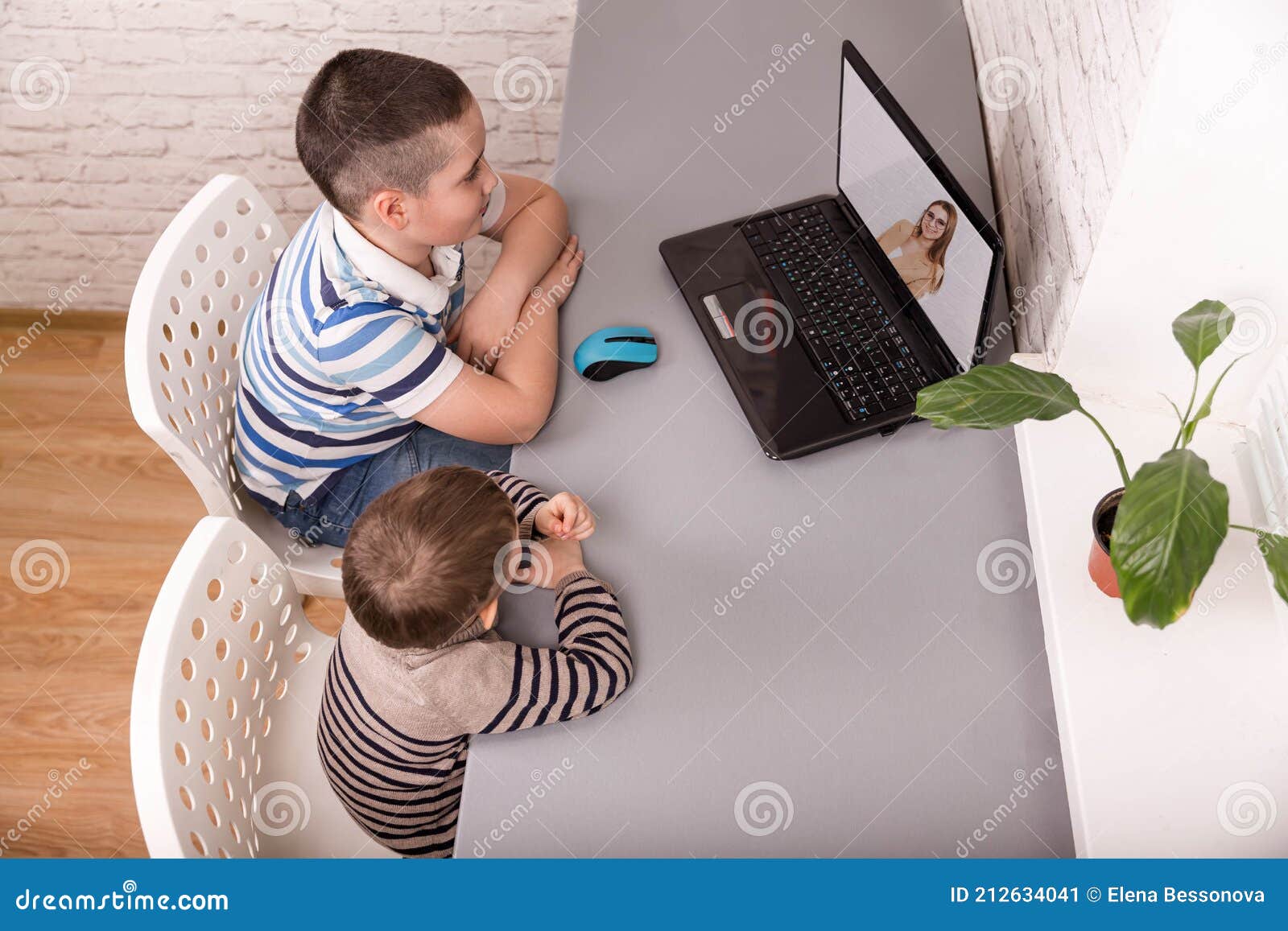 Brothers Looking at Laptop while E-learning. Boys Using Digital Table ...