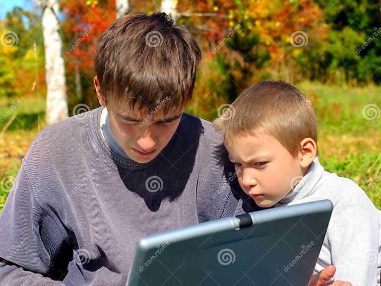 Brothers with notebook stock image. Image of computer - 13519793