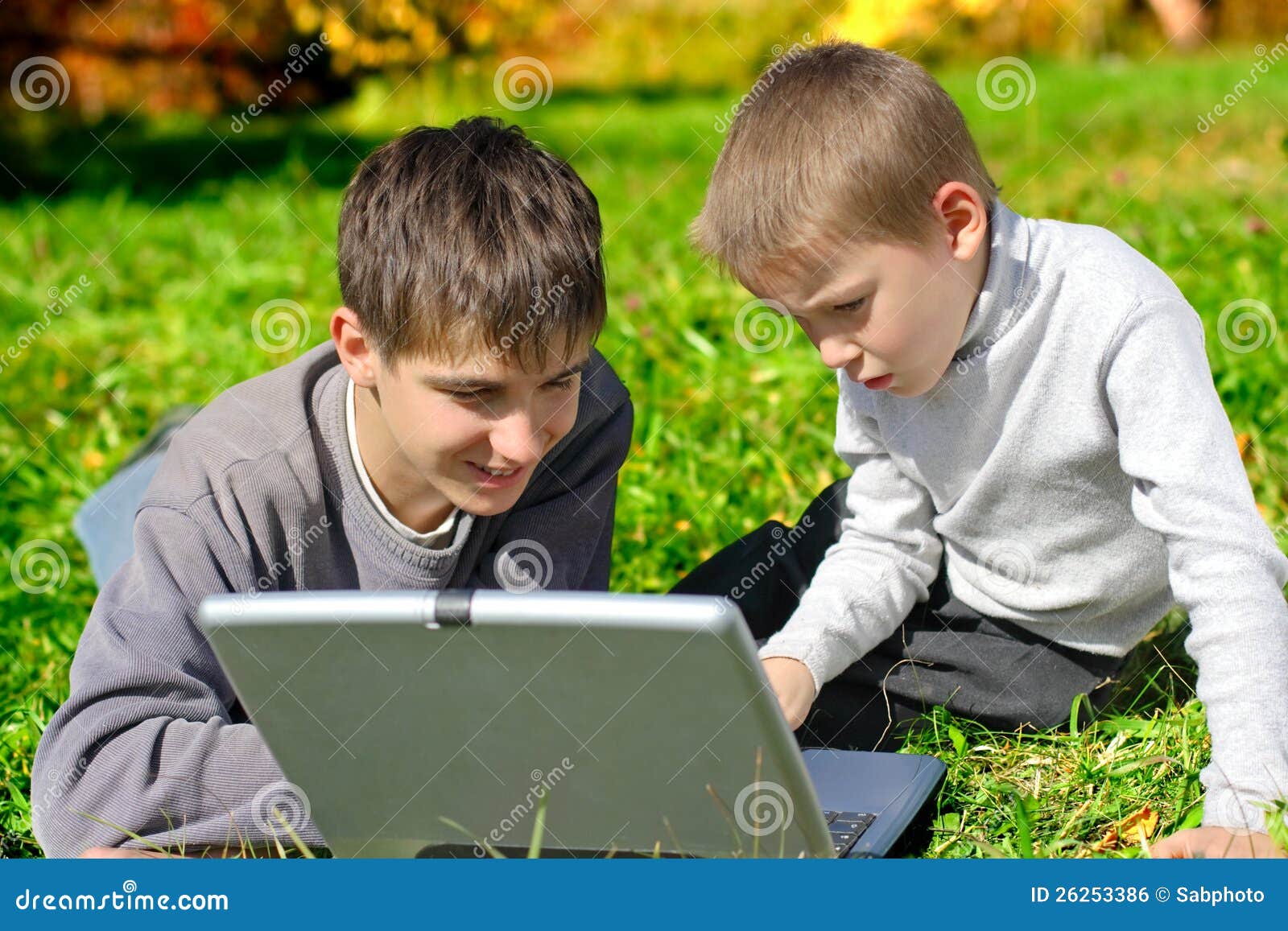 Brothers with notebook stock photo. Image of outdoors - 26253386