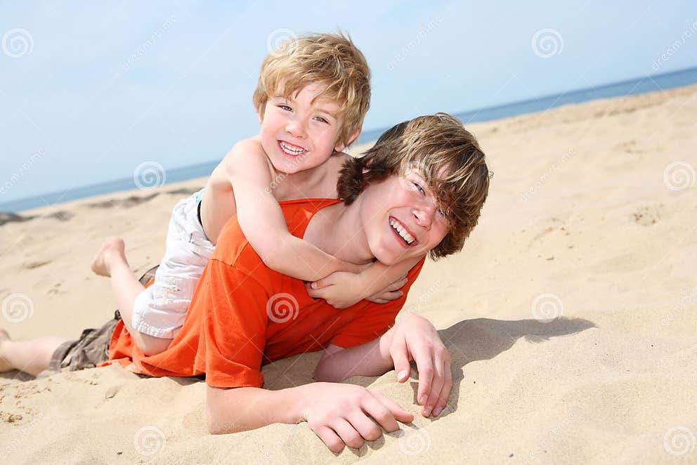 Brothers Playing on the Beach Stock Photo - Image of hugging, play: 7565430