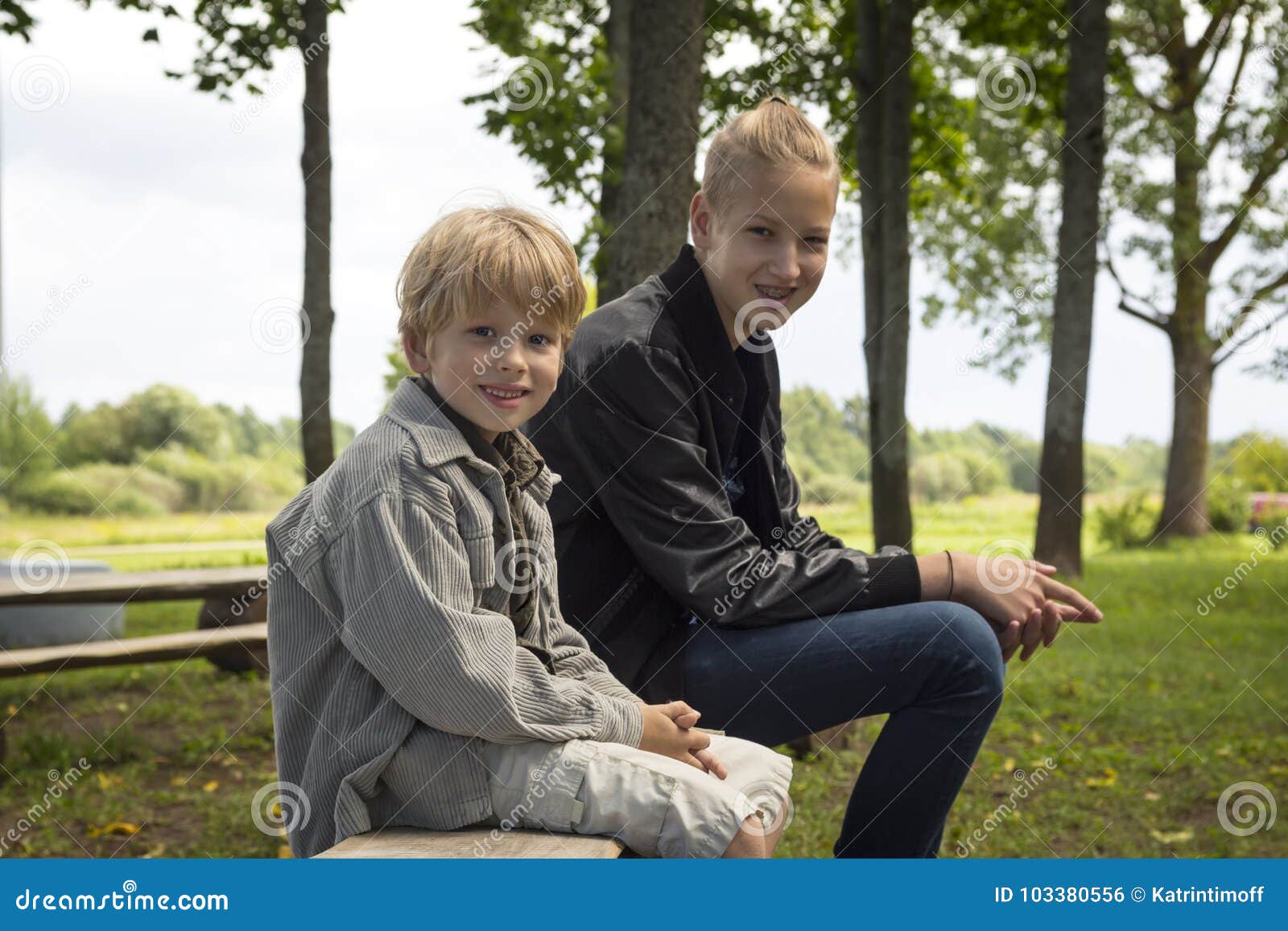 Brothers sit on a bench stock photo. Image of bench - 103380556