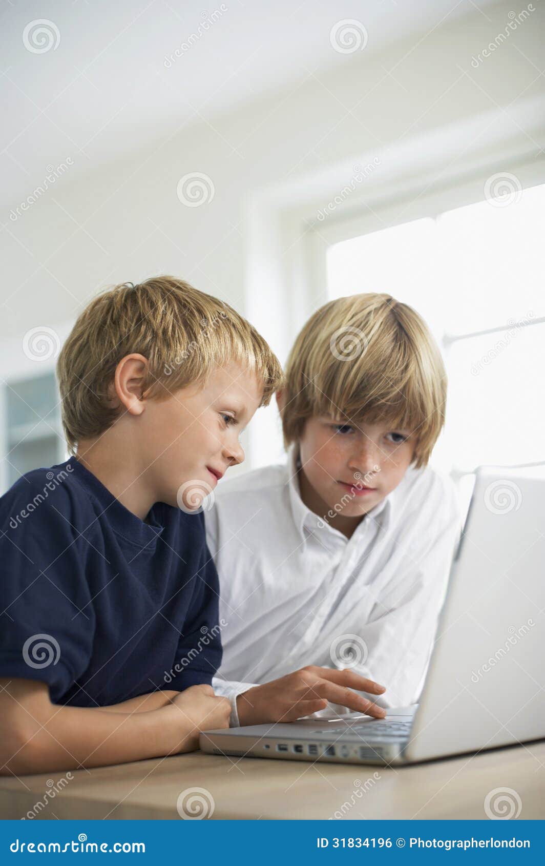 Brothers Using Laptop on Table Stock Photo - Image of people, family ...