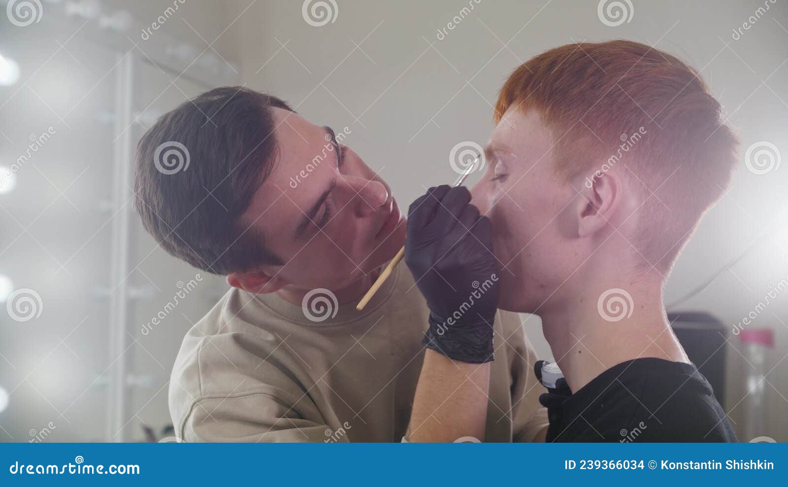 Brow Master Drawing Guiding Lines on the Eyebrows of His Male Client in ...