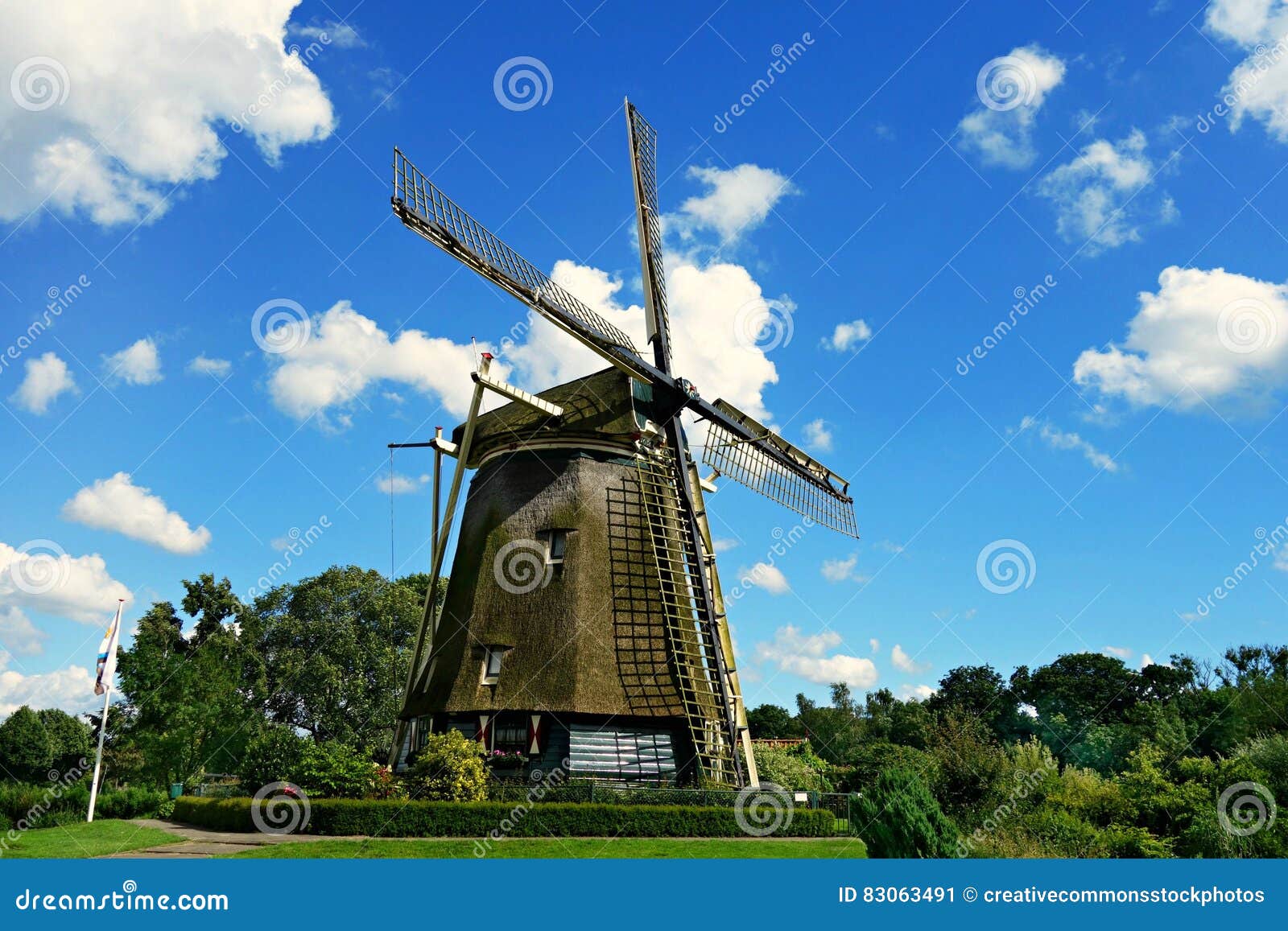 Brown And Black Windmill Under Cumulus Clouds Surrounded By Green Leaf ...