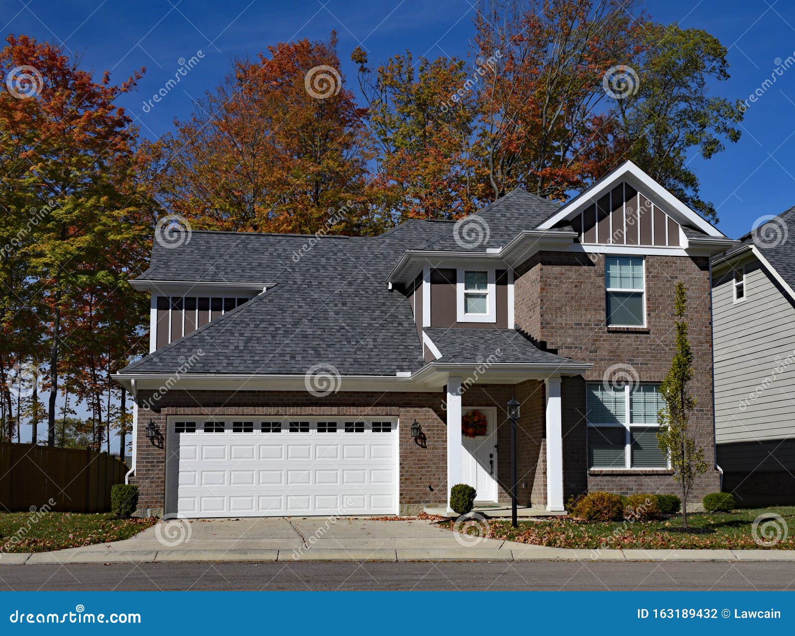 Brown Brick House with Fall Trees Background Stock Photo - Image of ...