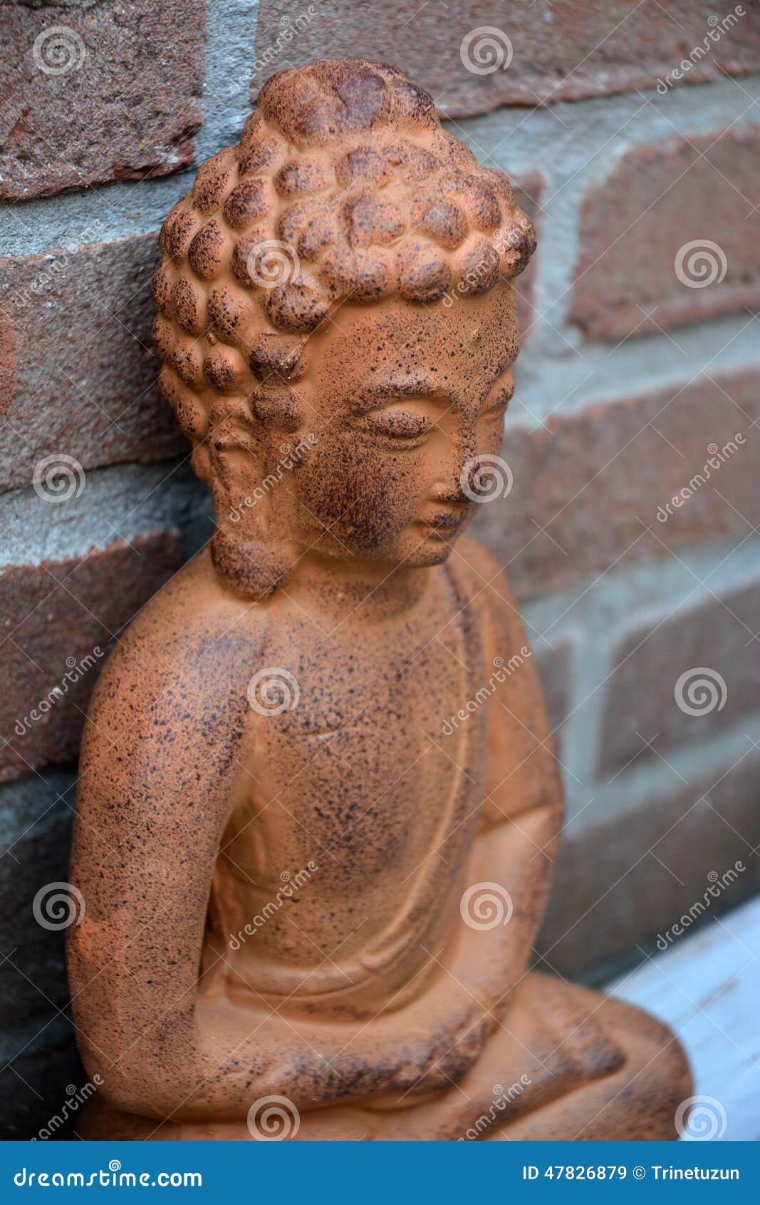 Brown Buddha With A Stone Bricks Wall Background Royalty-Free Stock ...