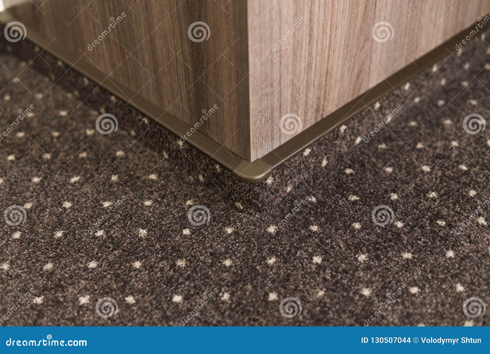 Brown Carpet Floor with a White Dots with a Carpet Baseboard on a Wood ...