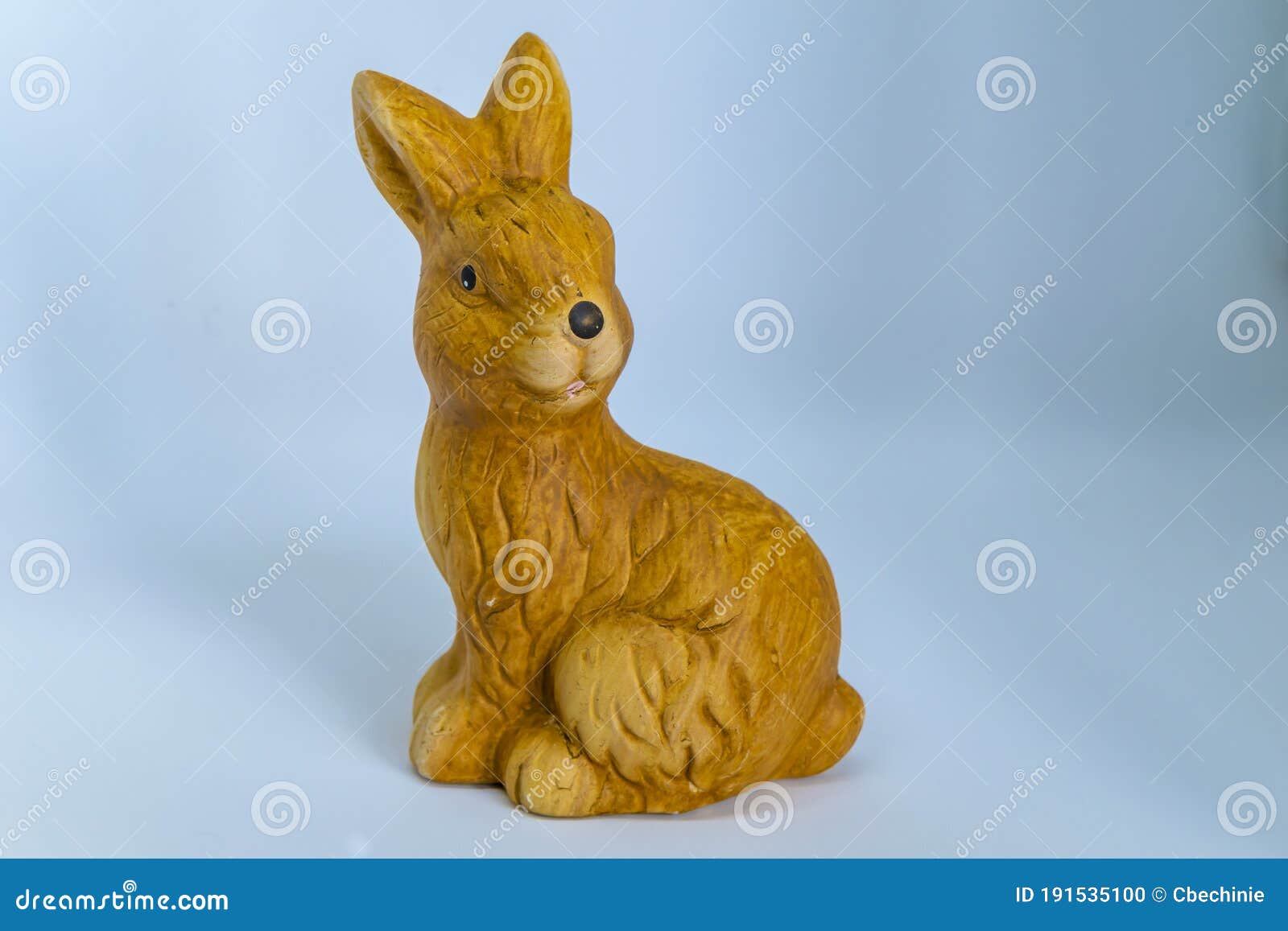 Brown Ceramic Rabbit in Front of a Blue Background Stock Photo - Image ...