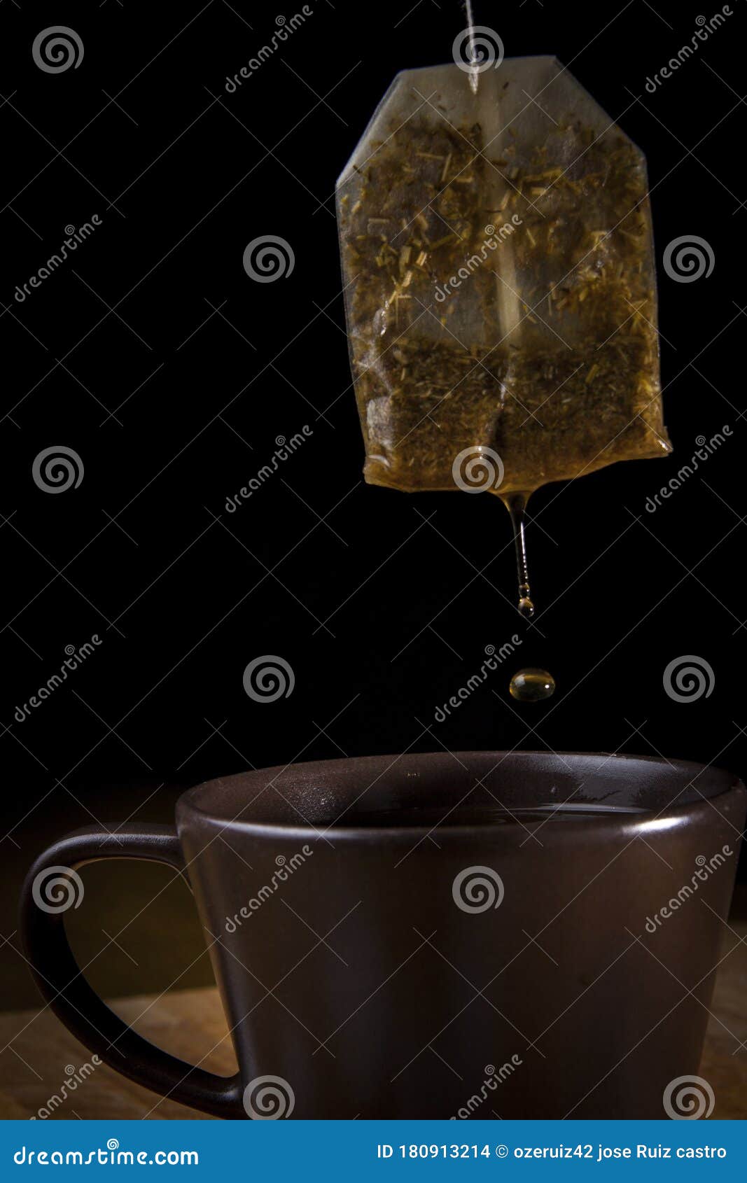 A Brown Cup on a Wooden Mass and on it a Dripping Tea Bag Stock Photo ...