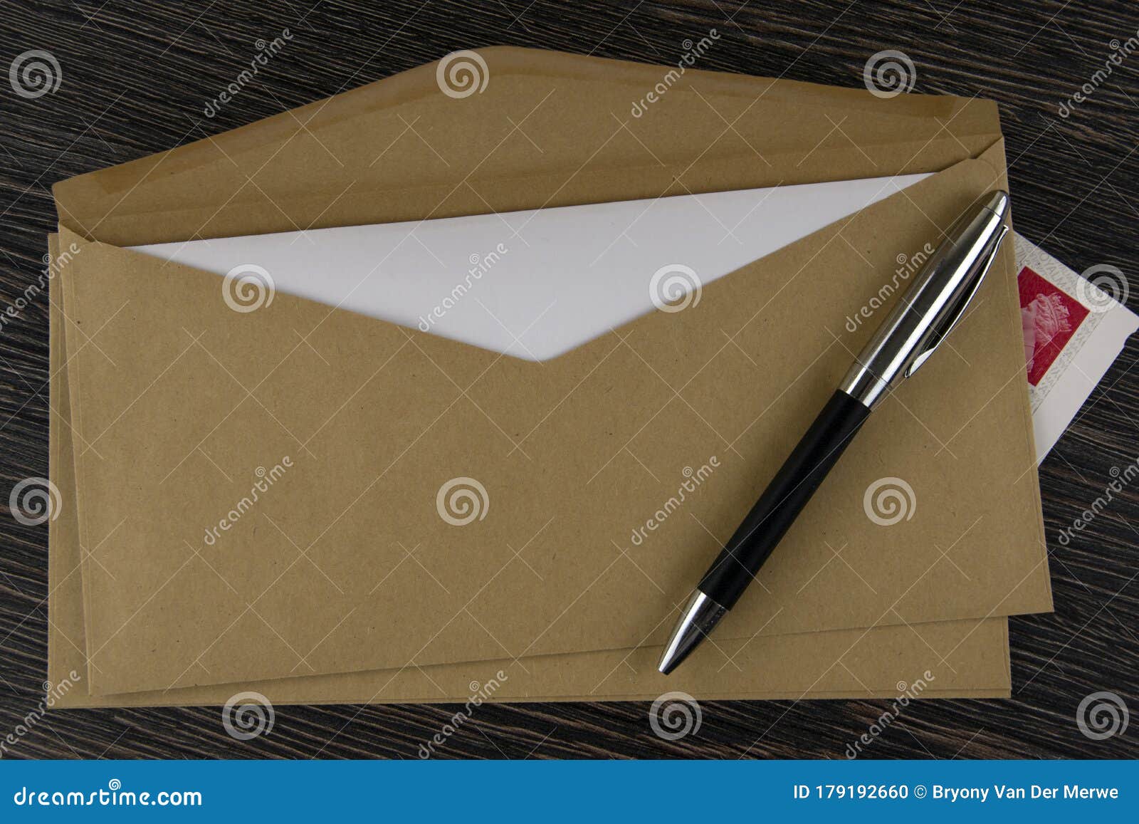 Brown Envelope, Pen and Stamps on Wooden Table Editorial Image - Image ...