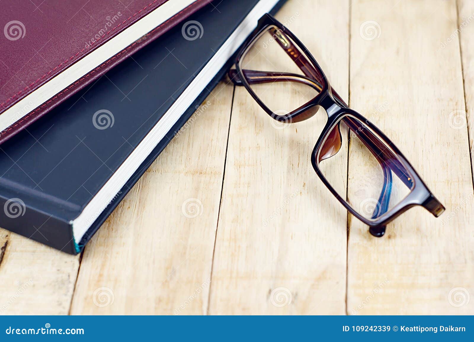 Brown Eyeglasses on Stack of the Book on Wooden Working Table. Stock ...