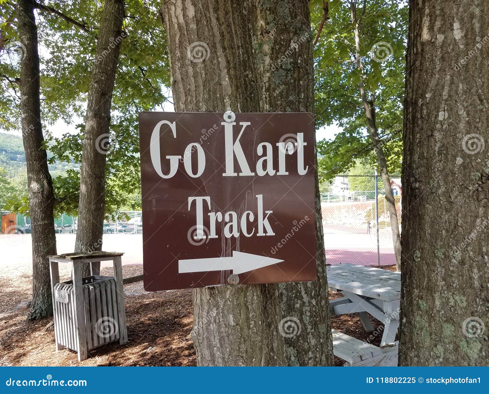 Brown Go Kart Track Sign on a Tree Stock Image - Image of cars, sign ...