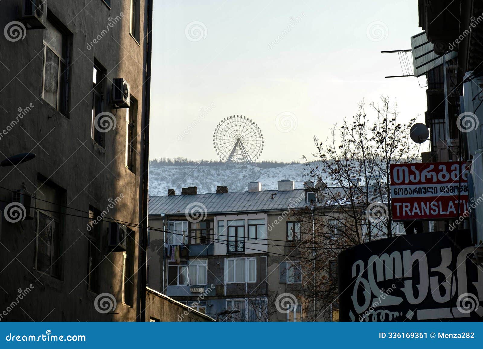 Brown Old Buildings with a Large Mountain in the Background Stock Image ...