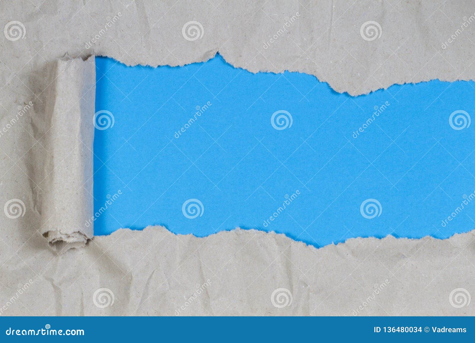 Brown Package Paper Torn To Reveal Blue Background with Copy Space ...