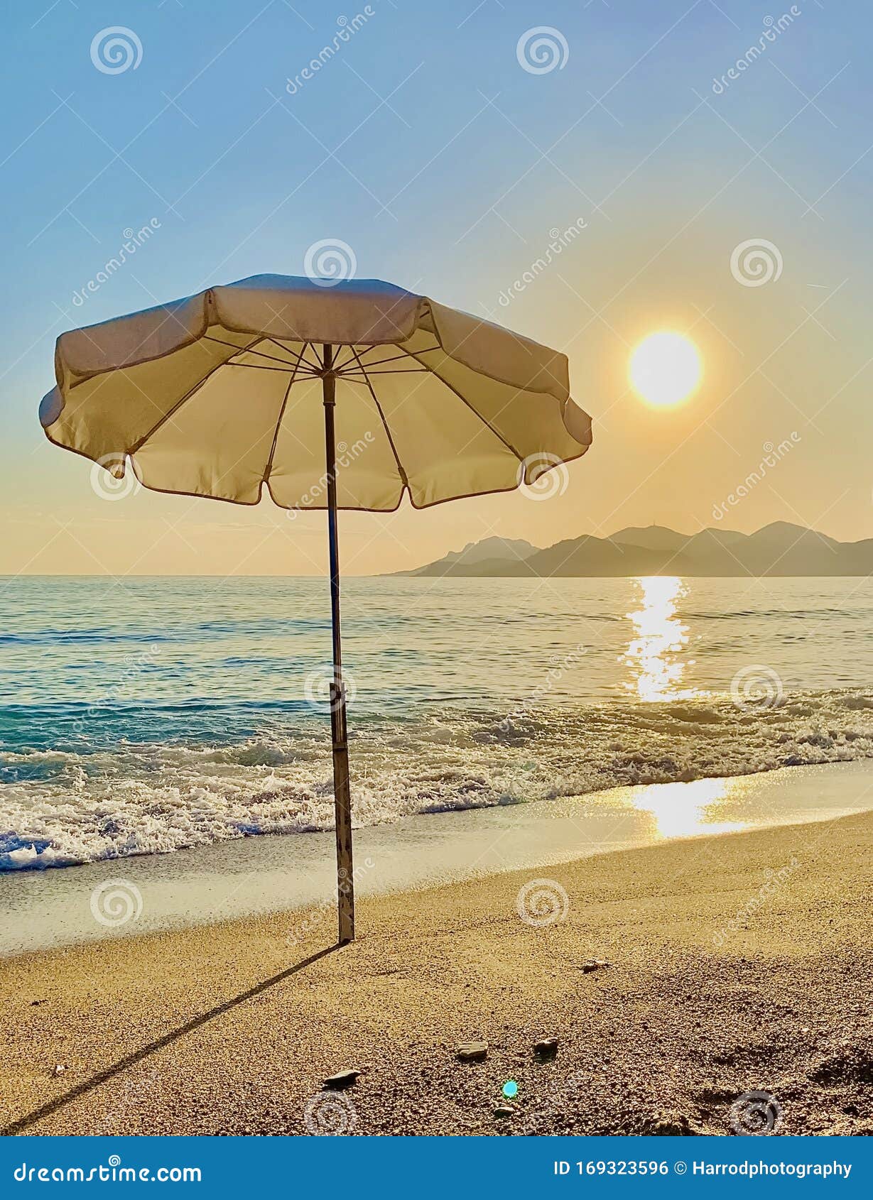 A Single Parasol on a Beach at Sunset Stock Photo - Image of beach ...