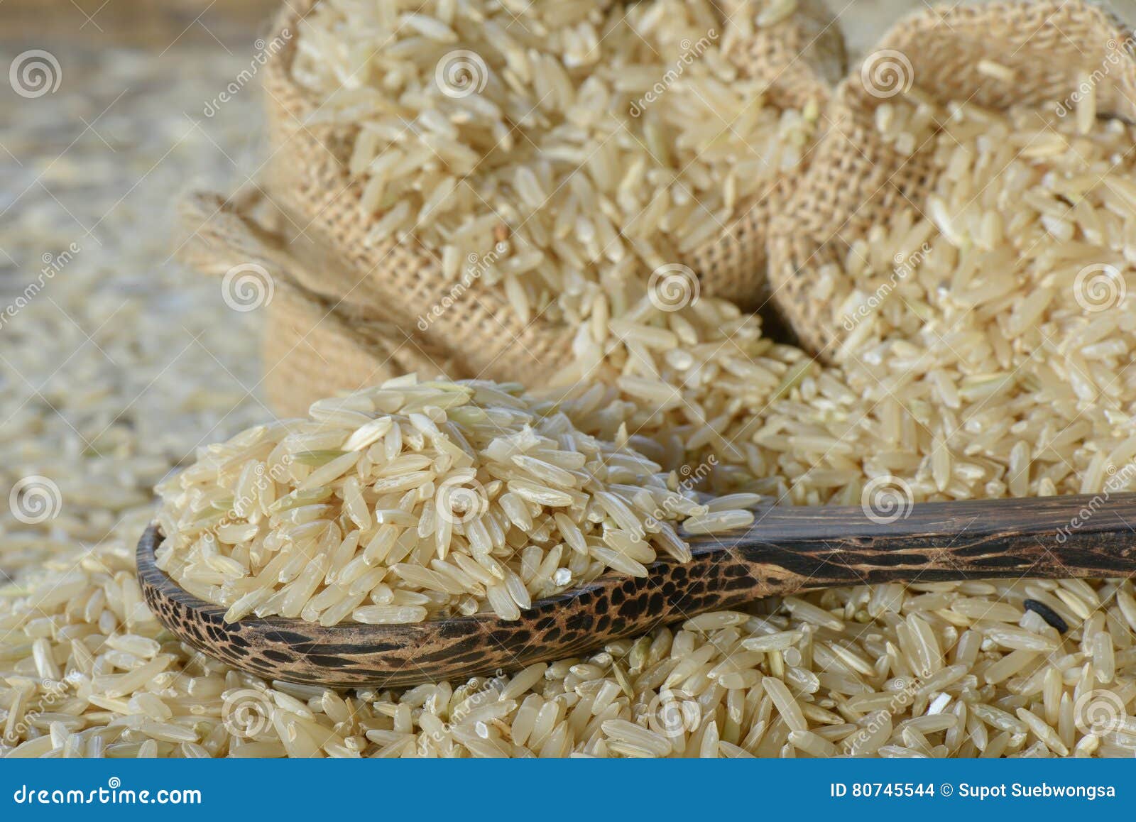 Brown rice on wooden spoon stock photo. Image of rice - 80745544